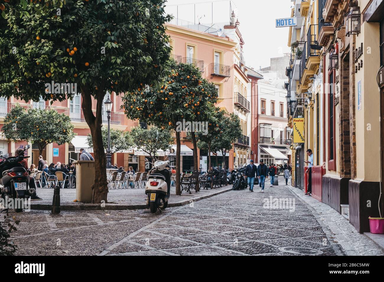 Seville, Spain - January 17, 2020: View of a charming paved street in ...