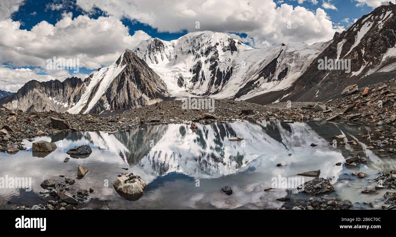 Highland lake with clear water and reflection of a mountain peak with a ...
