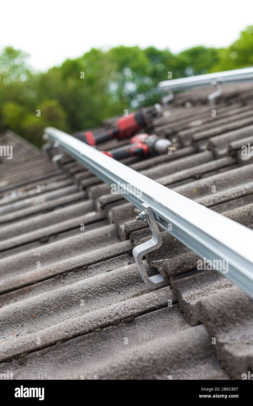 Close up of mounting rail for photovoltaic system on roof building site ...