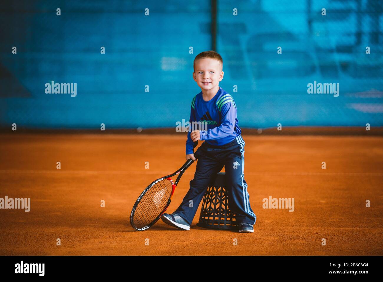 Child playing tennis on outdoor court. September 20, 2016. Ukraine ...
