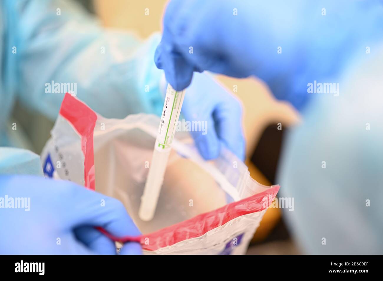 Oberteuringen, Germany. 10th Mar, 2020. A doctor puts a swab in a ...