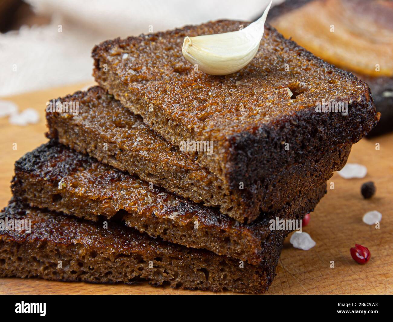 Garlic toasted bread. Bread and garlic. Peeled and grated garlic. Dark ...