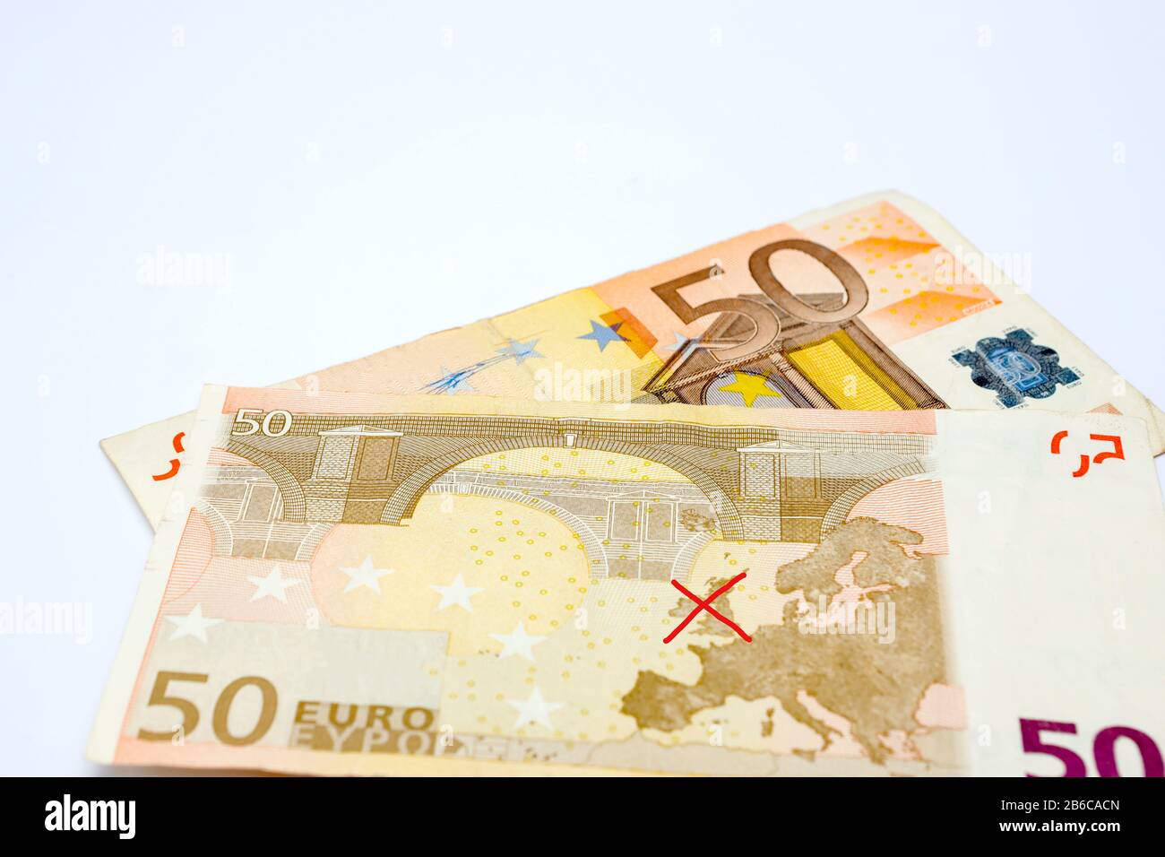 european bank note with a red cross on the map showing the eurpean ...