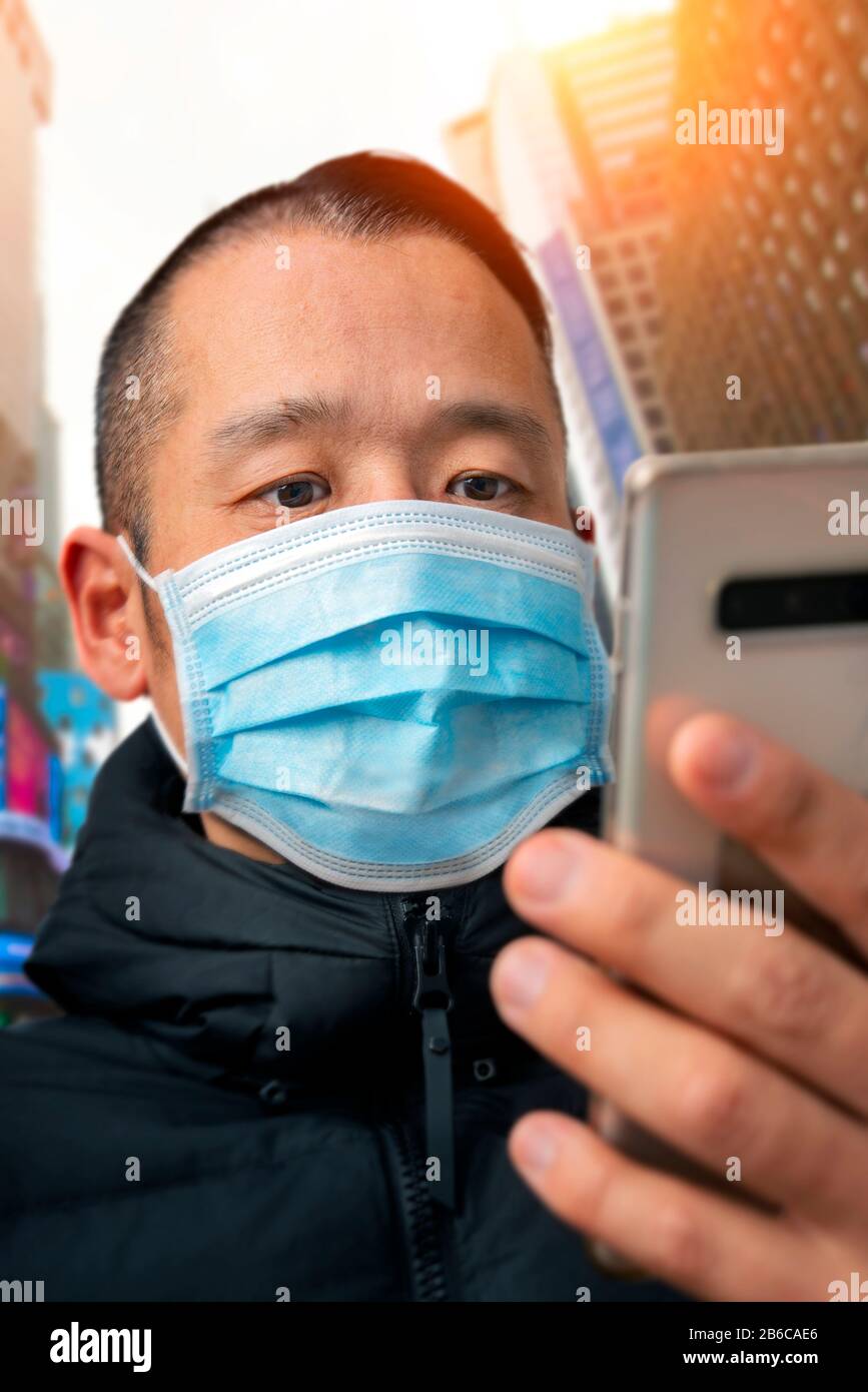Middle aged Asian man wearing medical face mask Stock Photo - Alamy