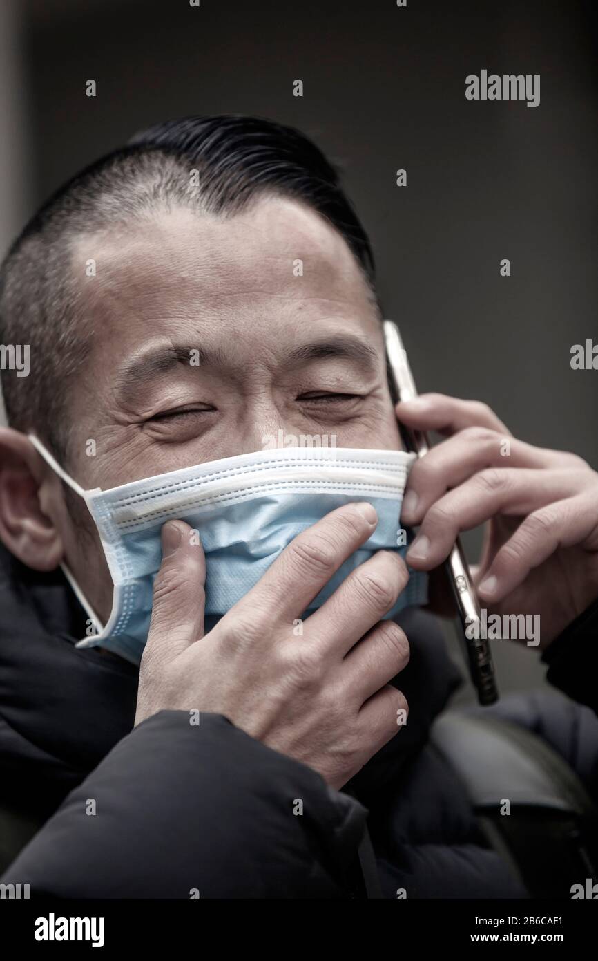 Middle aged Asian man wearing medical face mask Stock Photo - Alamy