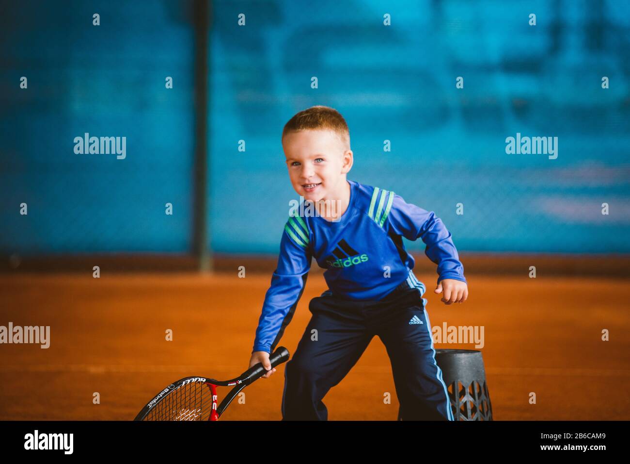 Child playing tennis on outdoor court. September 20, 2016. Ukraine ...