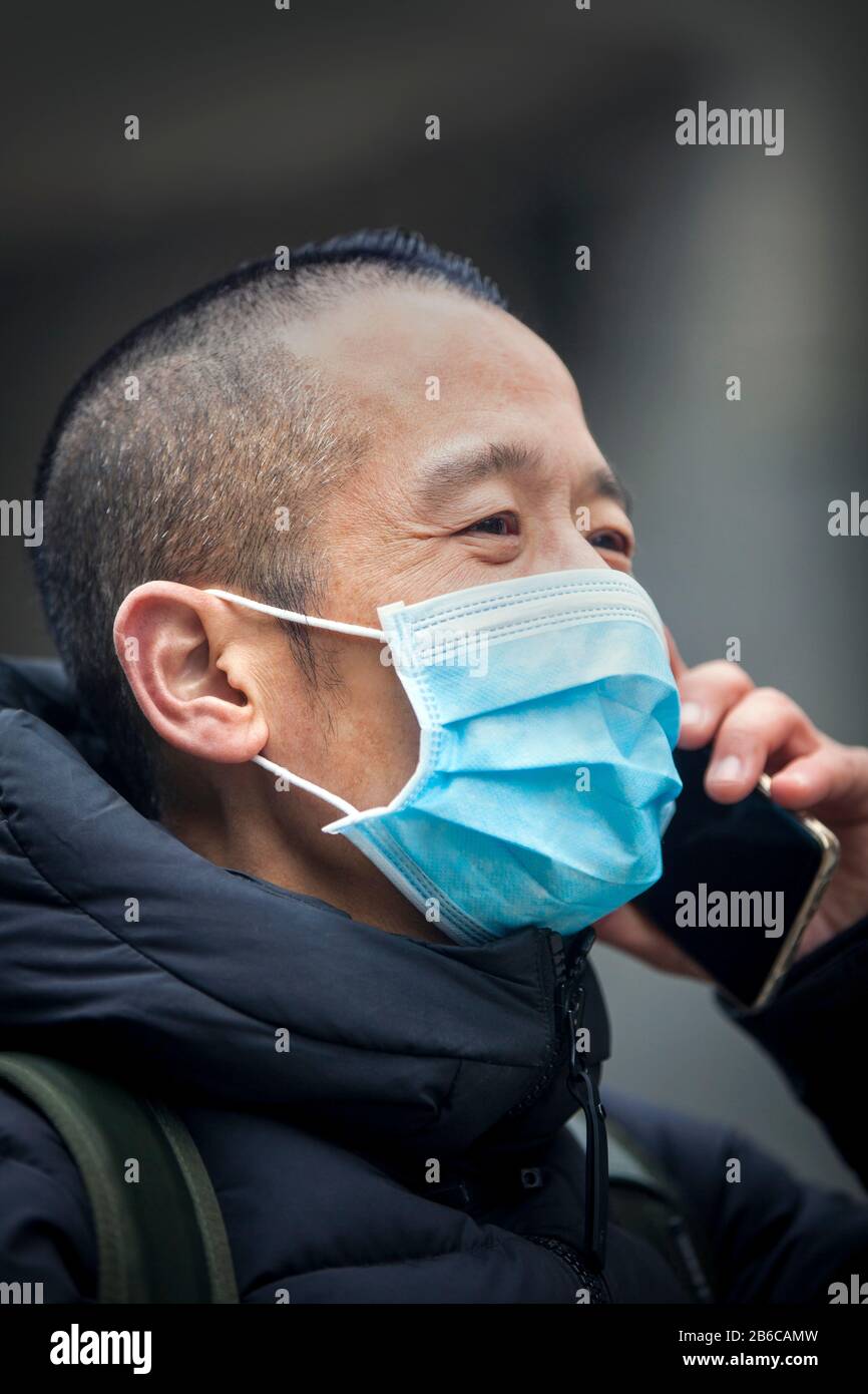 Middle aged Asian man wearing medical face mask Stock Photo - Alamy