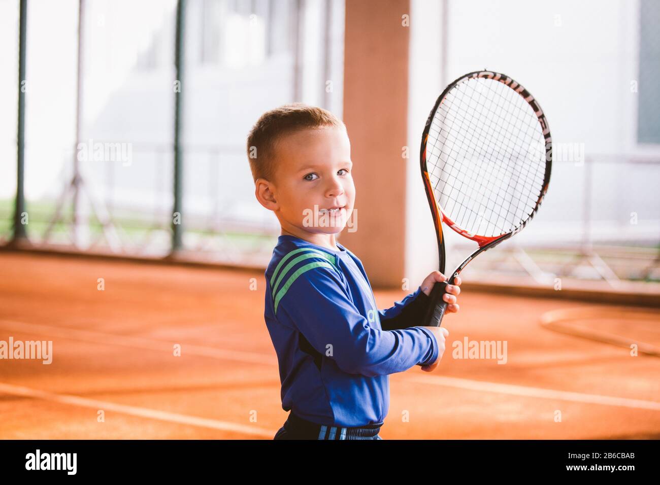 Child playing tennis on outdoor court. September 20, 2016. Ukraine ...
