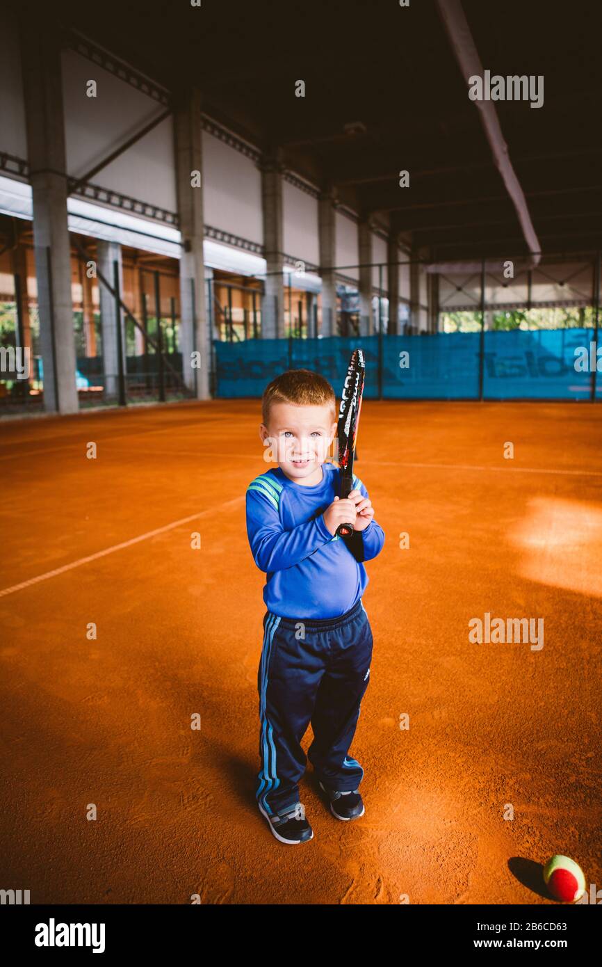 Child playing tennis on outdoor court. September 20, 2016. Ukraine ...