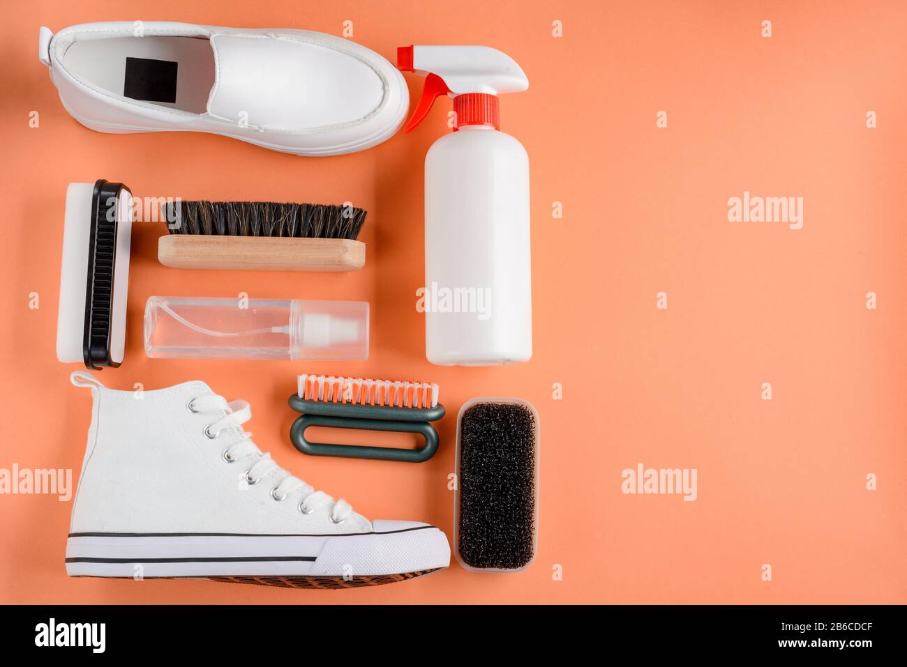 Cleaning products for shoes on orange background Stock Photo - Alamy