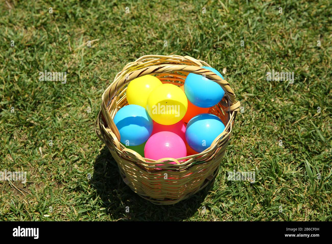 Inside the basket are balls of yellow, dark blue, purpure balls. A ...