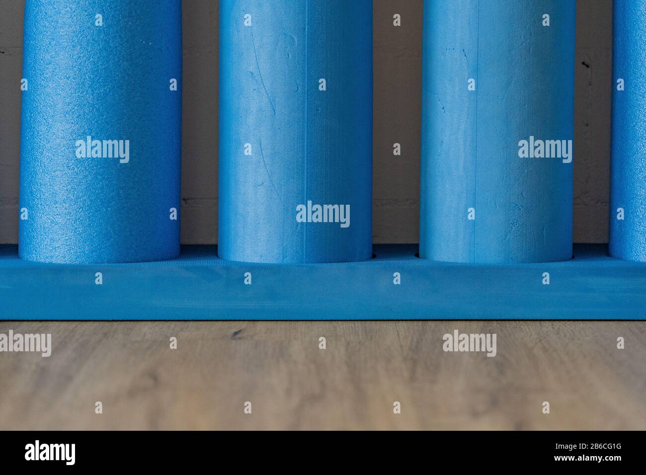 Blue rigid foam stem on wooden oak floor with white brick wall in ...