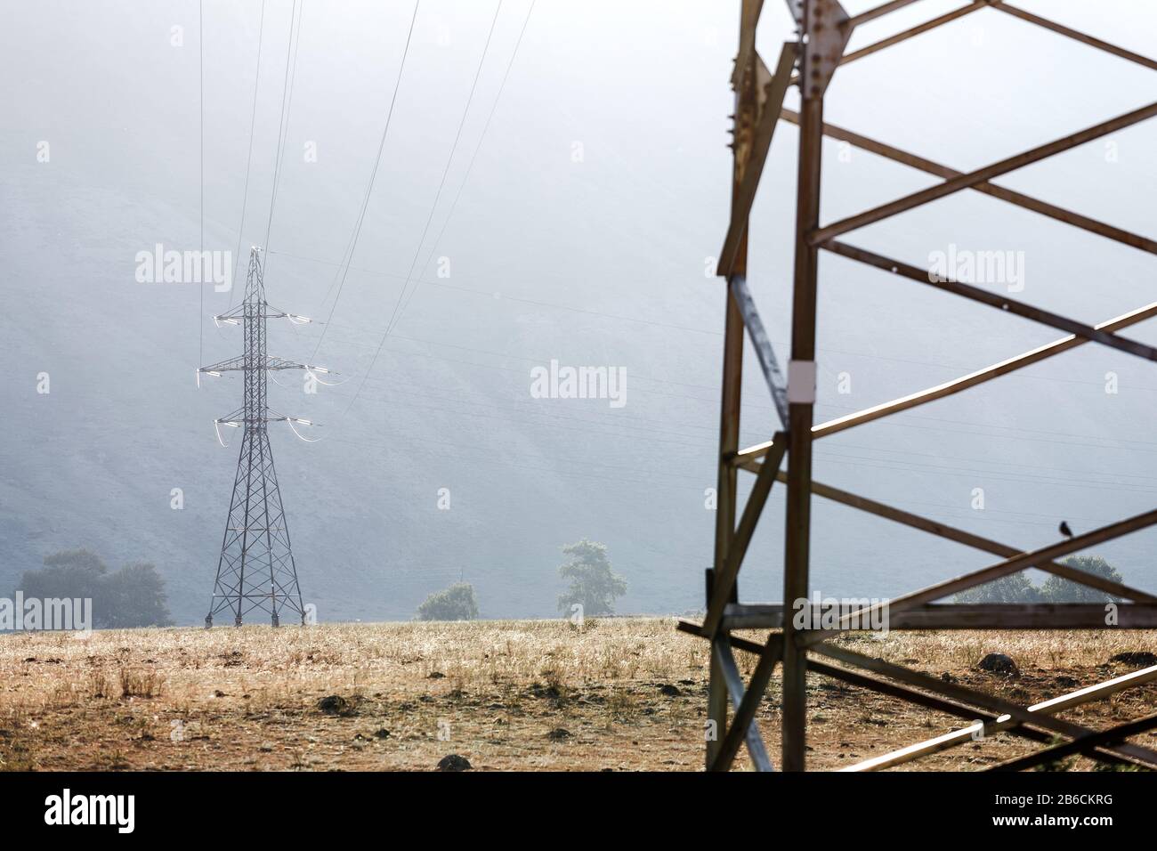 Metal high voltage power line support Stock Photo - Alamy