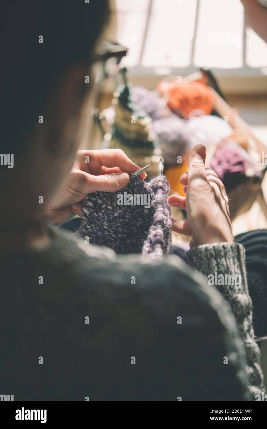 woman sitting on settee knitting Stock Photo - Alamy