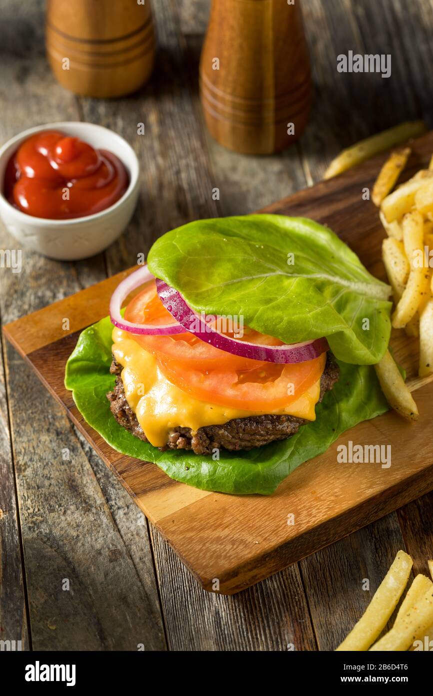 Healthy Hamburger in a Lettuce Bun with Cheese and Fries Stock Photo ...