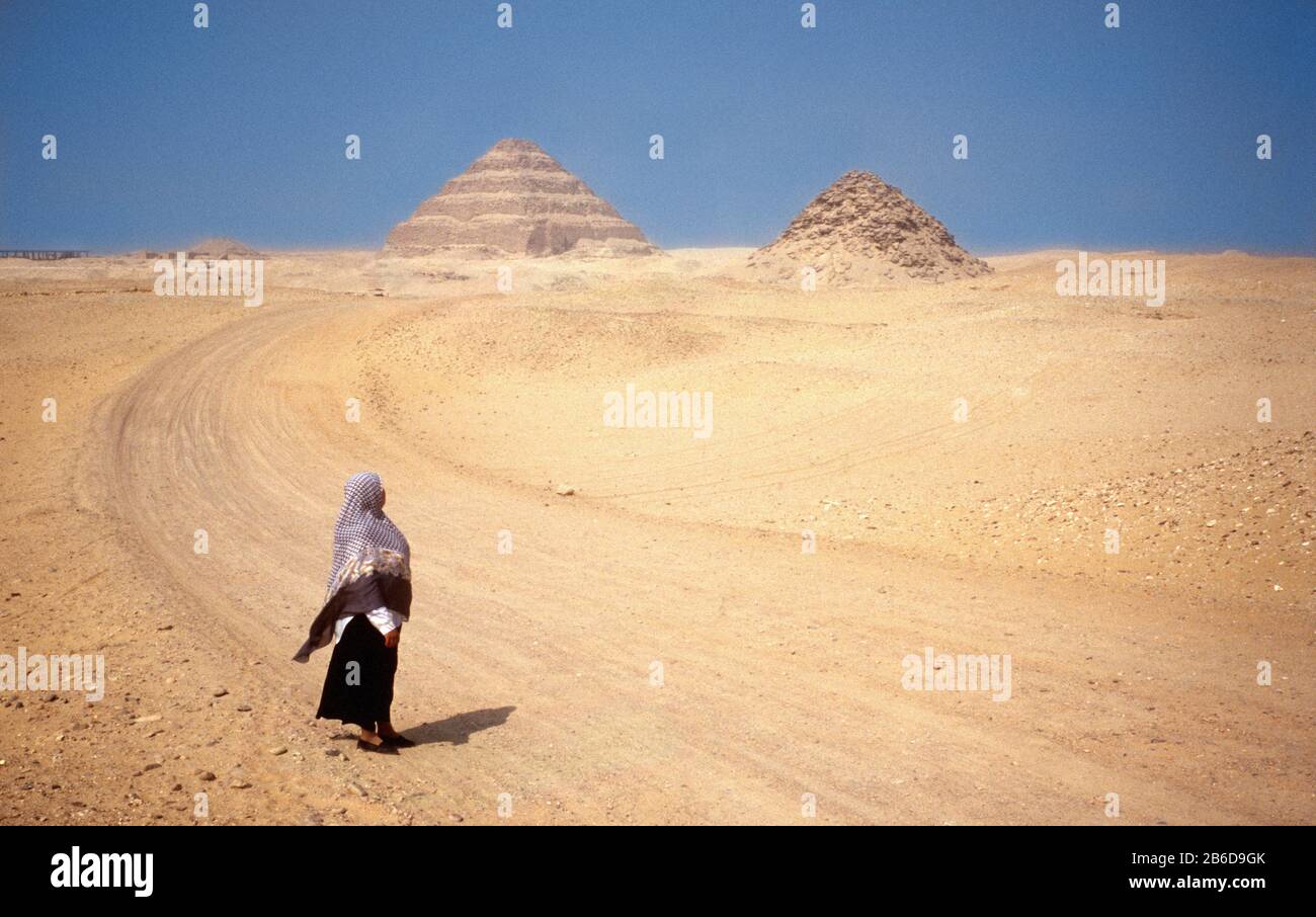 A woman is standing and looking at the pyramids, Egypt Stock Photo - Alamy