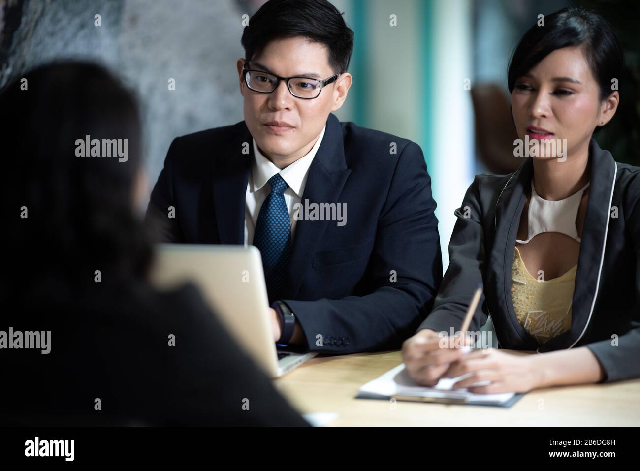 Human resources manager conducting job interview with applicants in ...