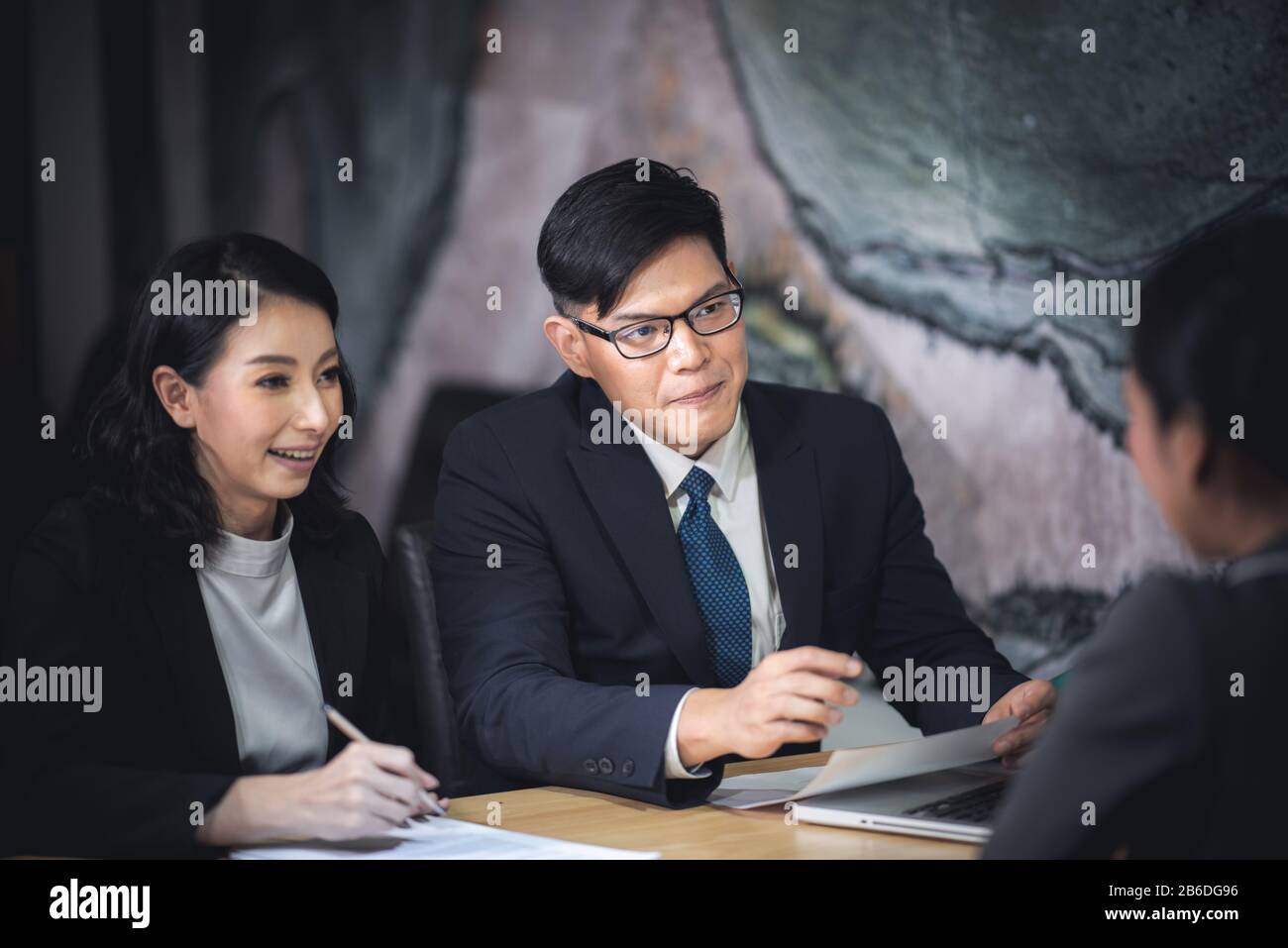 Human resources manager conducting job interview with applicants in ...