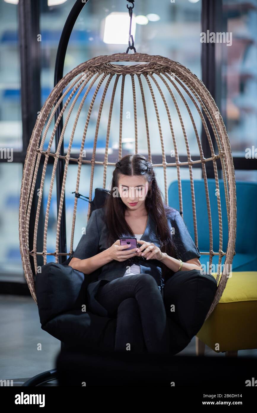 Happy young Asian woman answer phone from customer with her business ...