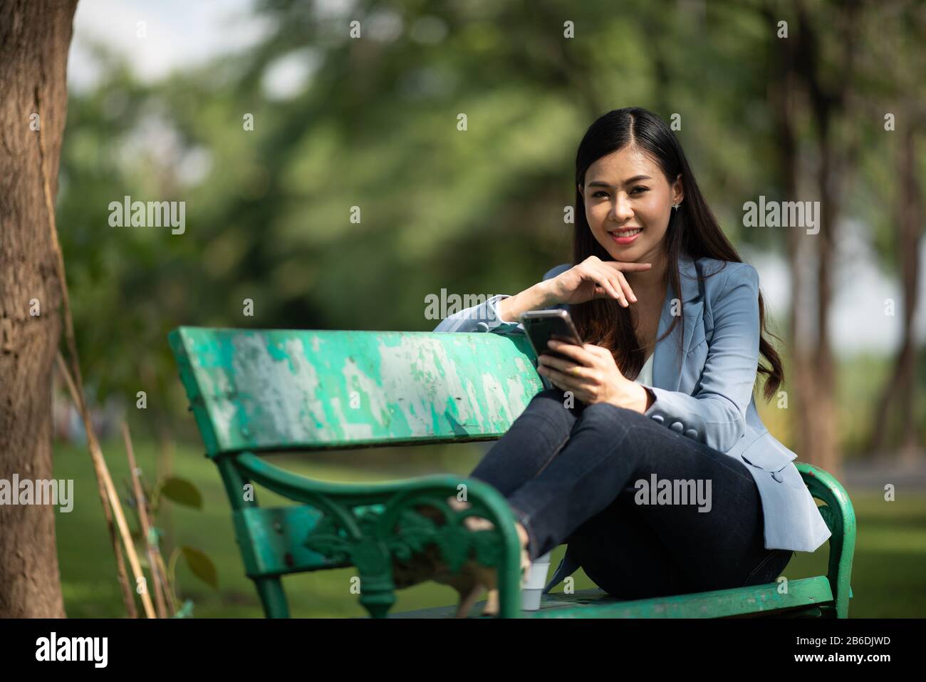 Happy young Asian woman answer phone from customer with her business ...