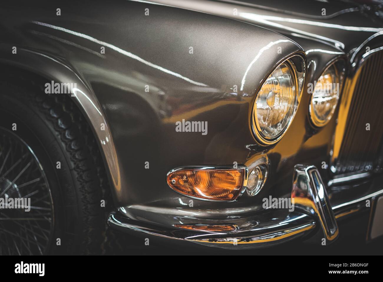 Front-side details of the grille, wheel and headlamps of a classic car ...