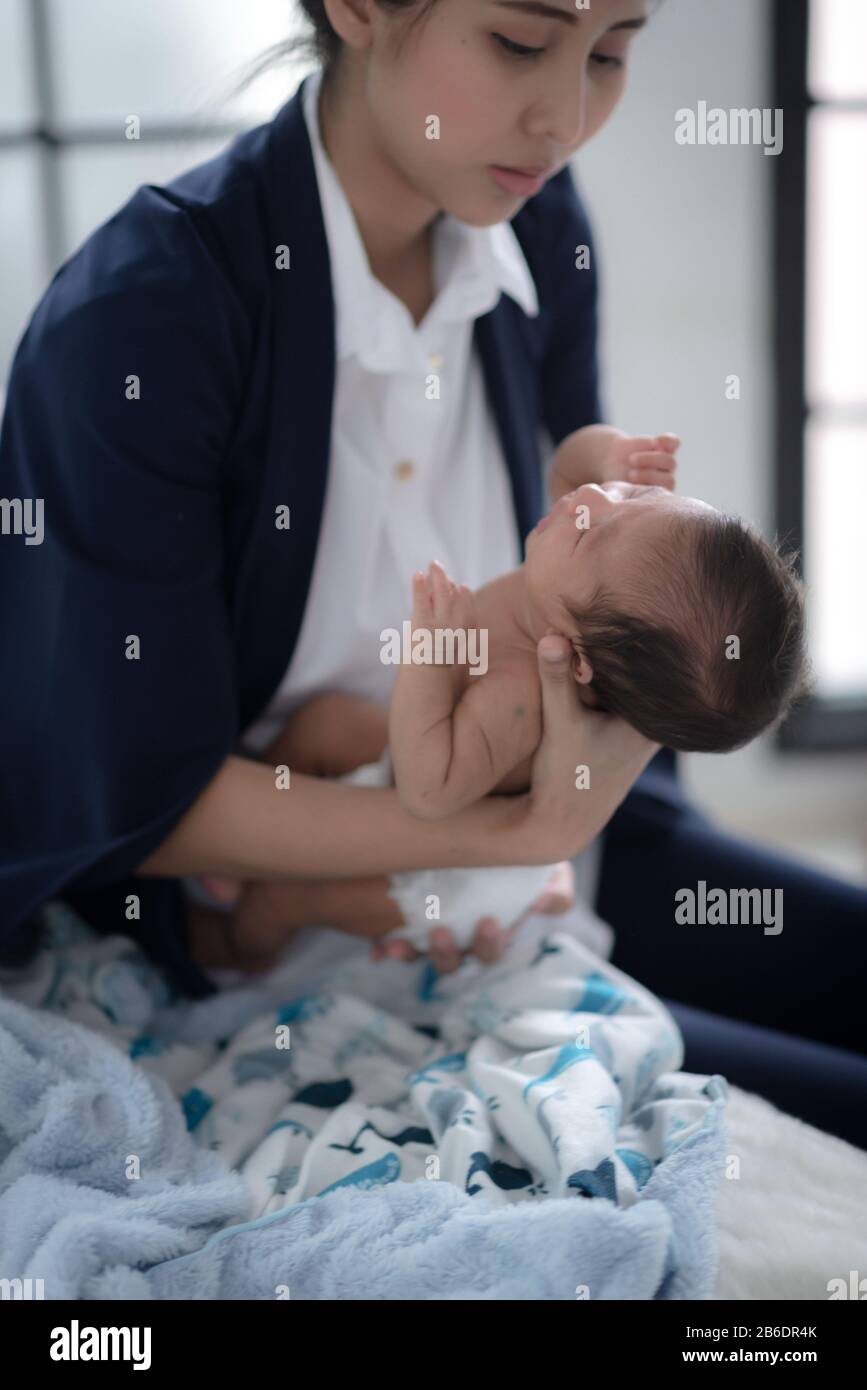 The business mother is raising children and working together Stock ...