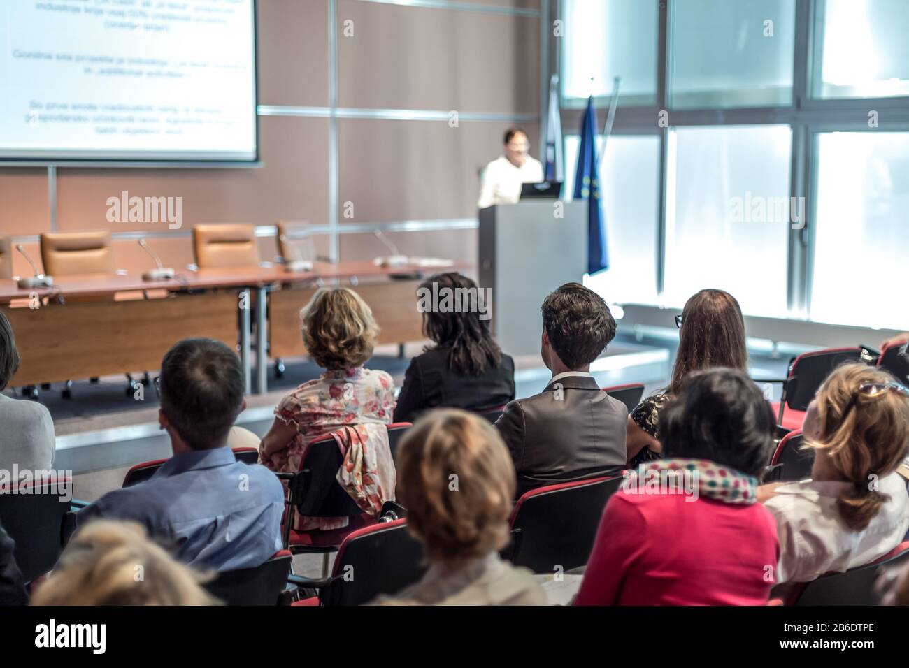 Woman giving presentation in lecture hall at university Stock Photo - Alamy
