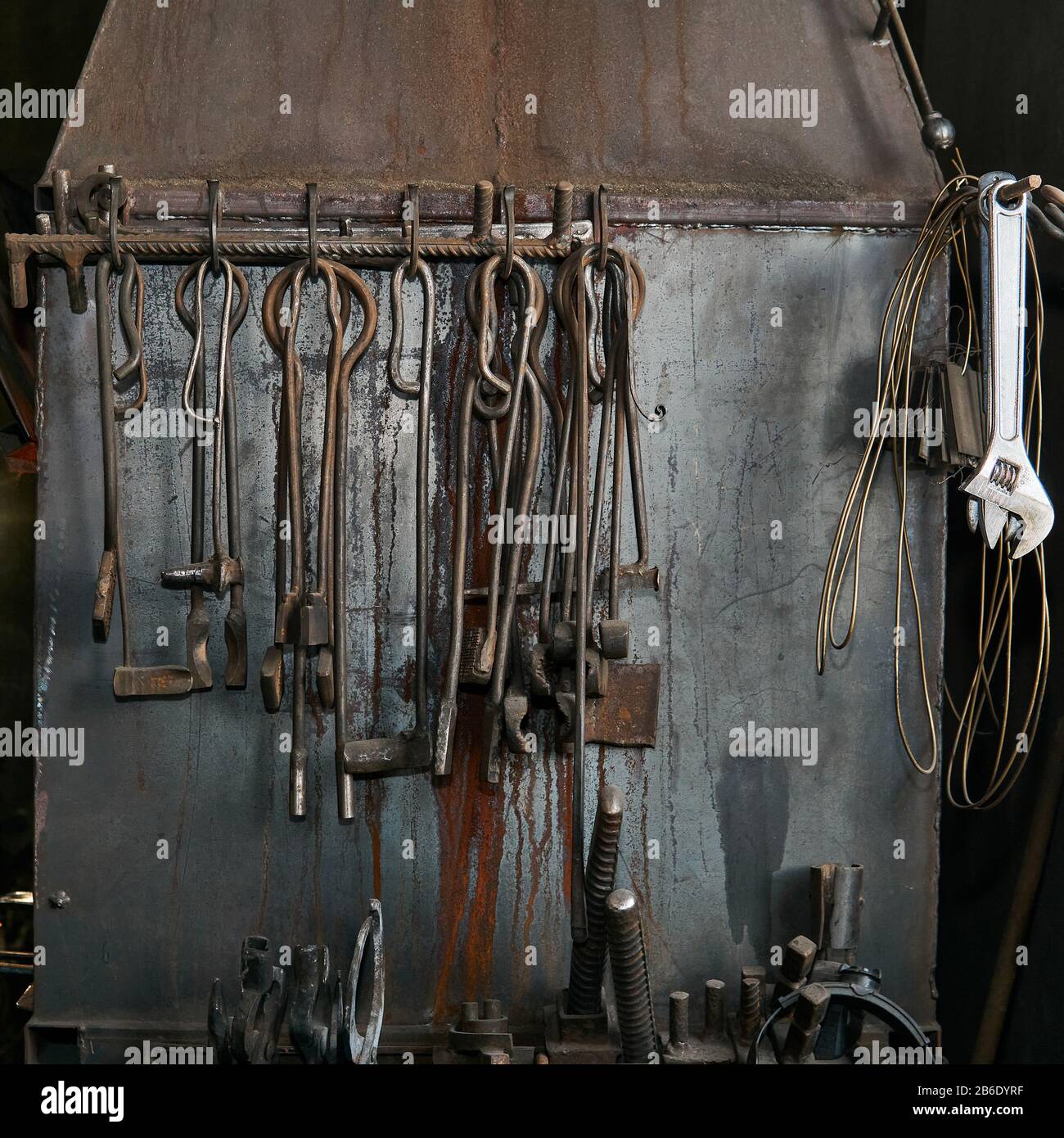 rough iron vintage blacksmith and locksmith tools hung on the metal ...