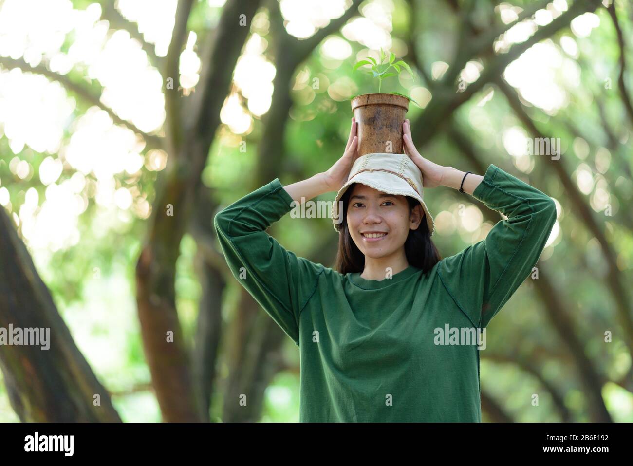Image of an Asian woman In the concept of planting trees for the ...