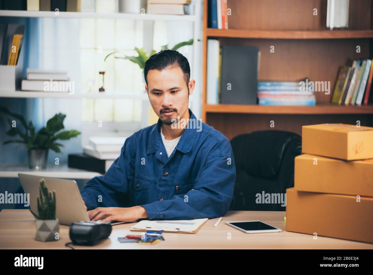 The man working laptop computer from home on wooden floor with postal ...
