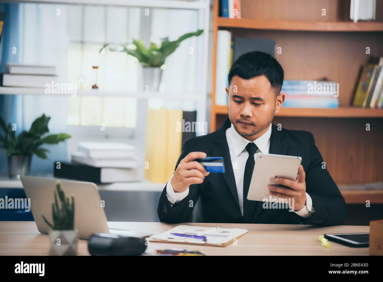 Business people use credit cards to do financial transactions at work ...