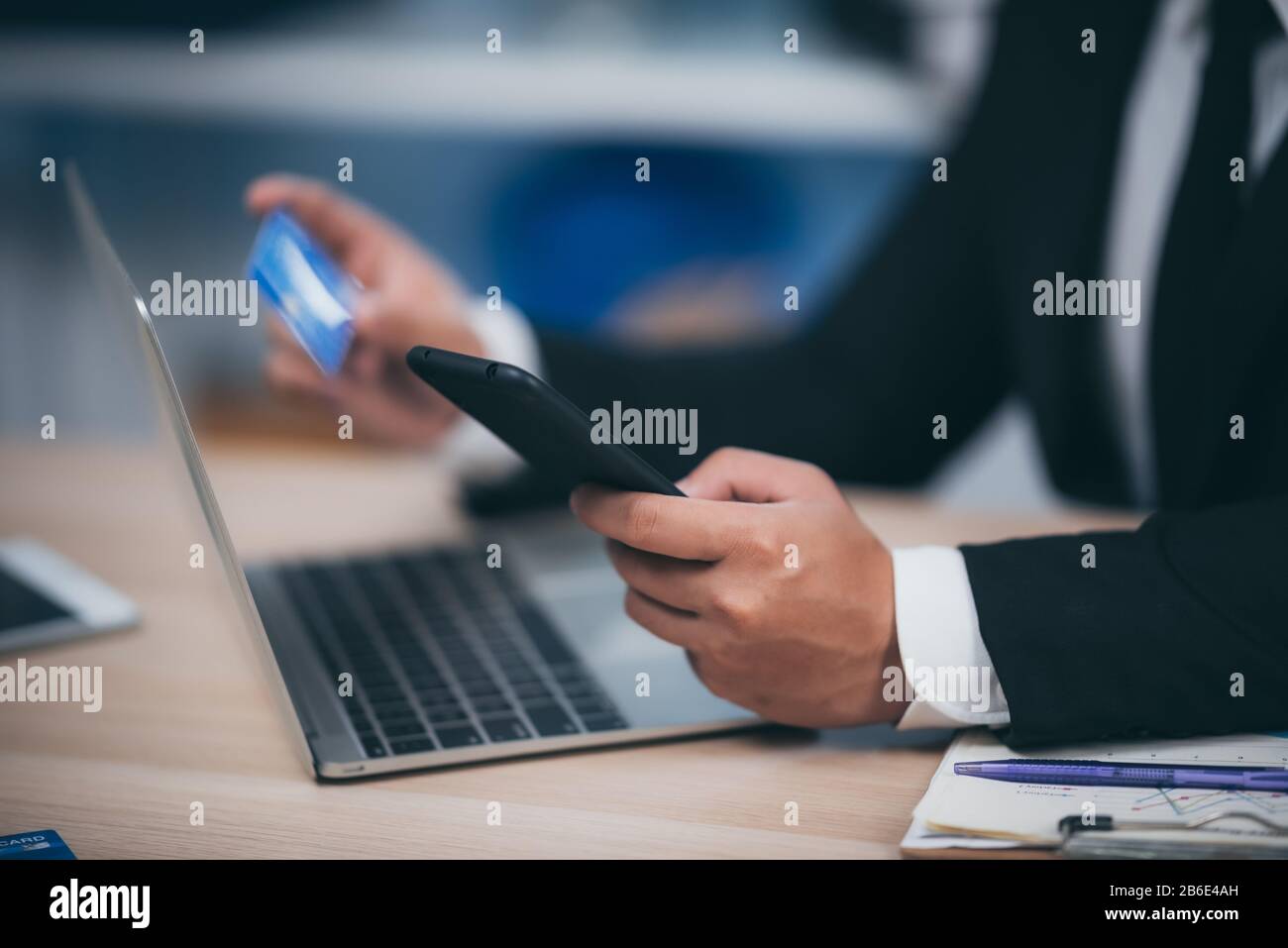 Business people use credit cards to do financial transactions at work ...