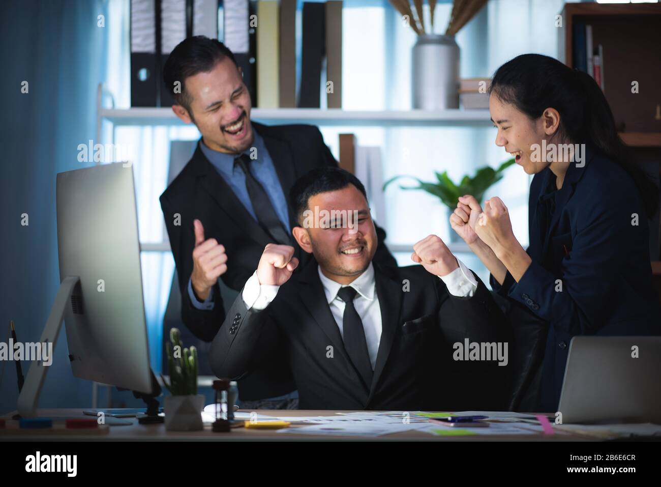 Happy employees positive manager celebrating hi-res stock photography ...