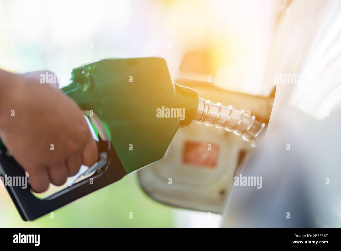 Man Handle pumping gasoline fuel nozzle to refuel. Vehicle fueling ...