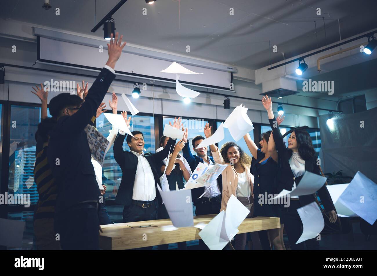 Group of business people rejoicing in closing the quarter successfully ...