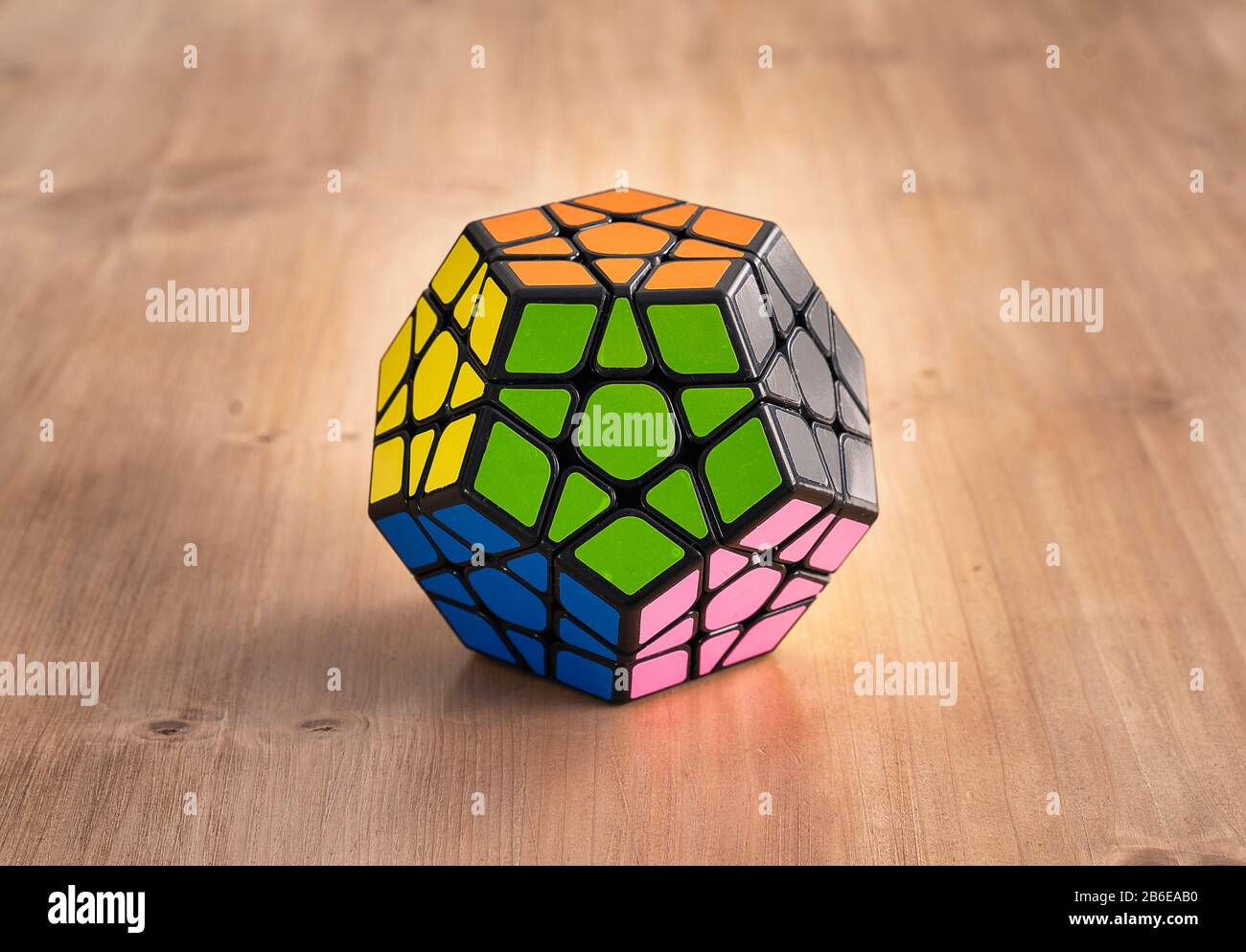 Rubik twelve sides cube solved in a wood table Stock Photo - Alamy