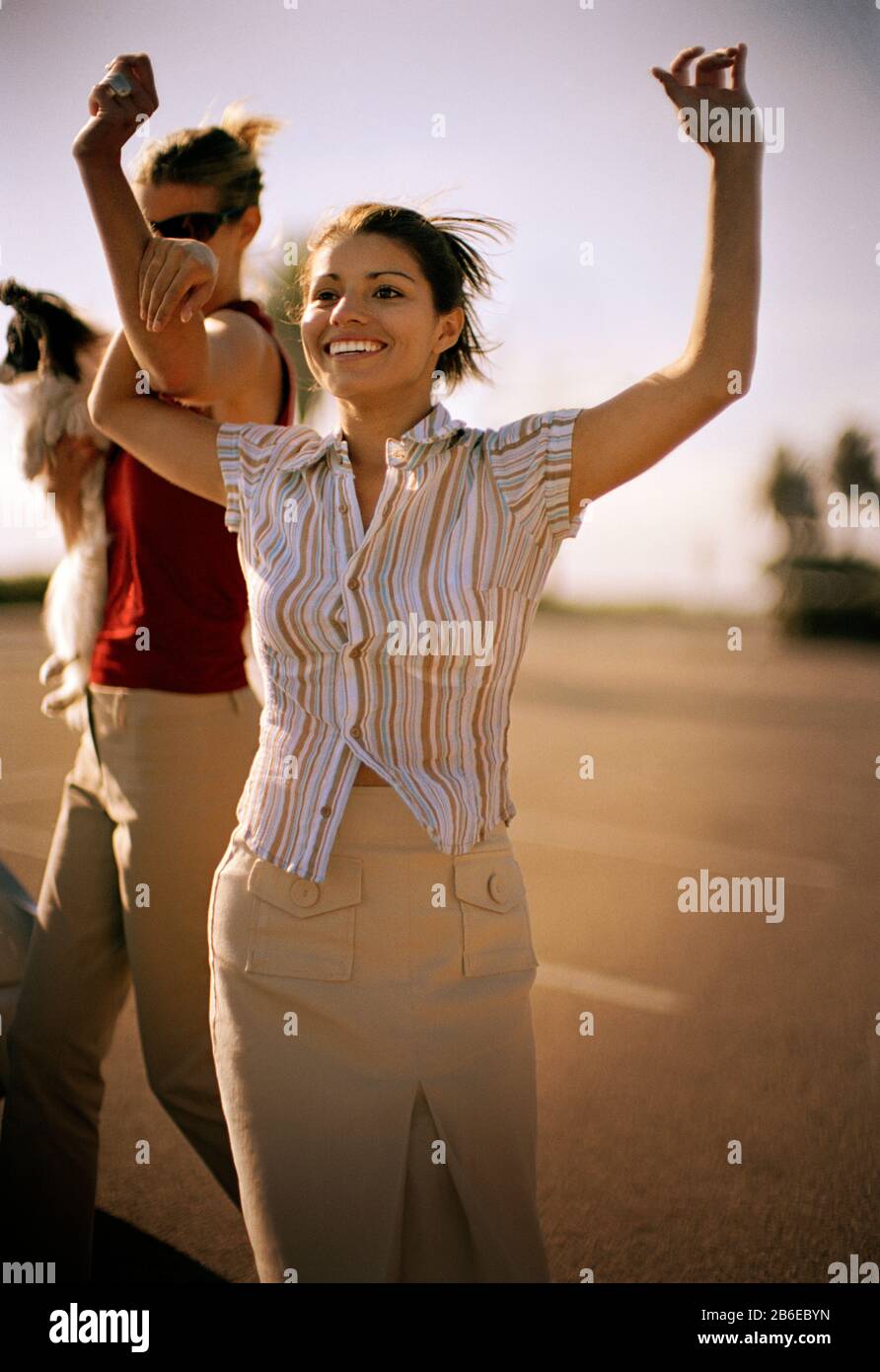 two women arms up rejoicing Stock Photo - Alamy