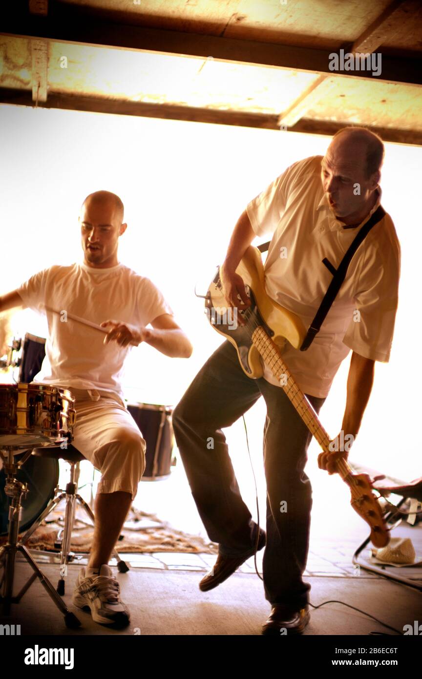 Two men are playing musical instruments Stock Photo - Alamy