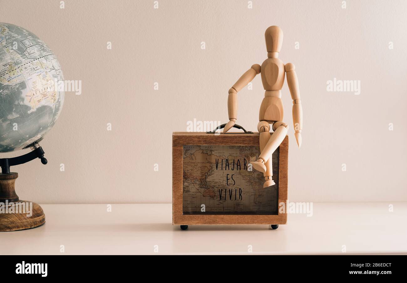 Wooden figure planning a travel with suitcase, lifestyle Stock Photo ...