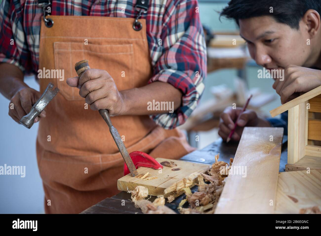 Carpenter working on woodworking machines in carpentry shop, wooden ...