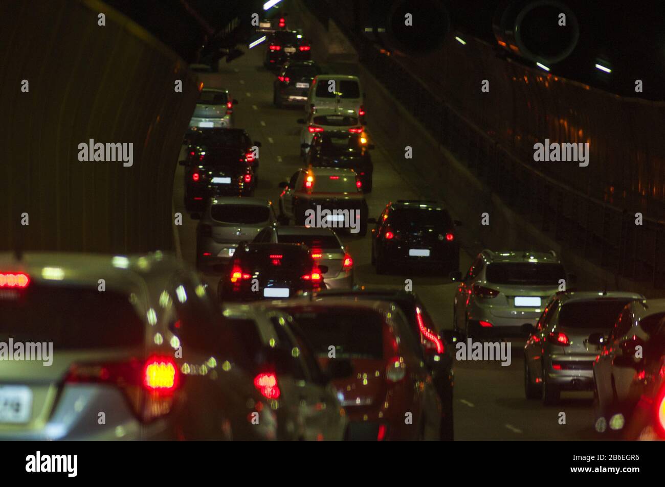 slow moving traffic in tunnel with passenger cars changing lanes Stock ...