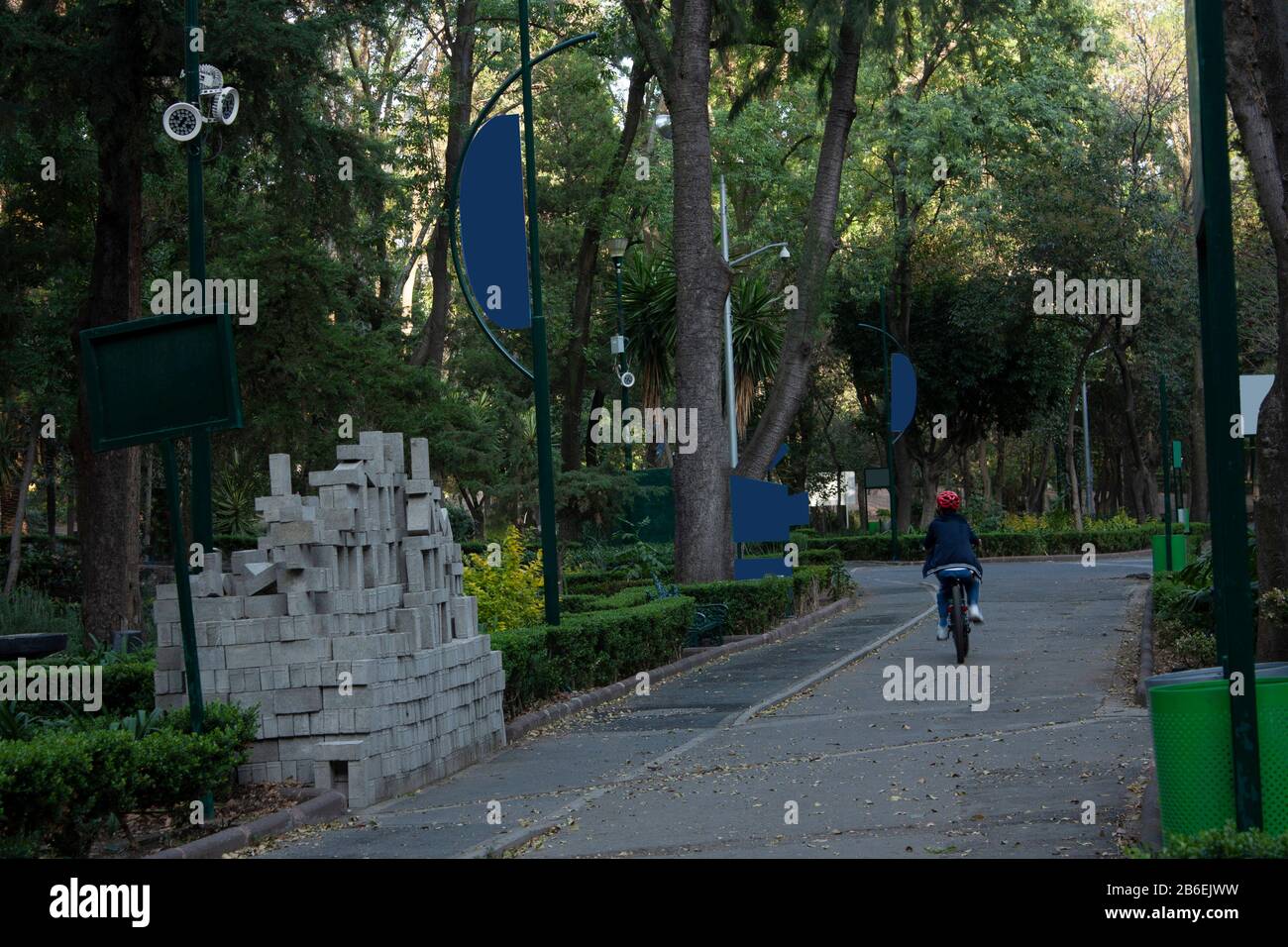 Sunken park with bricks and path where a person travels by bicycle in ...