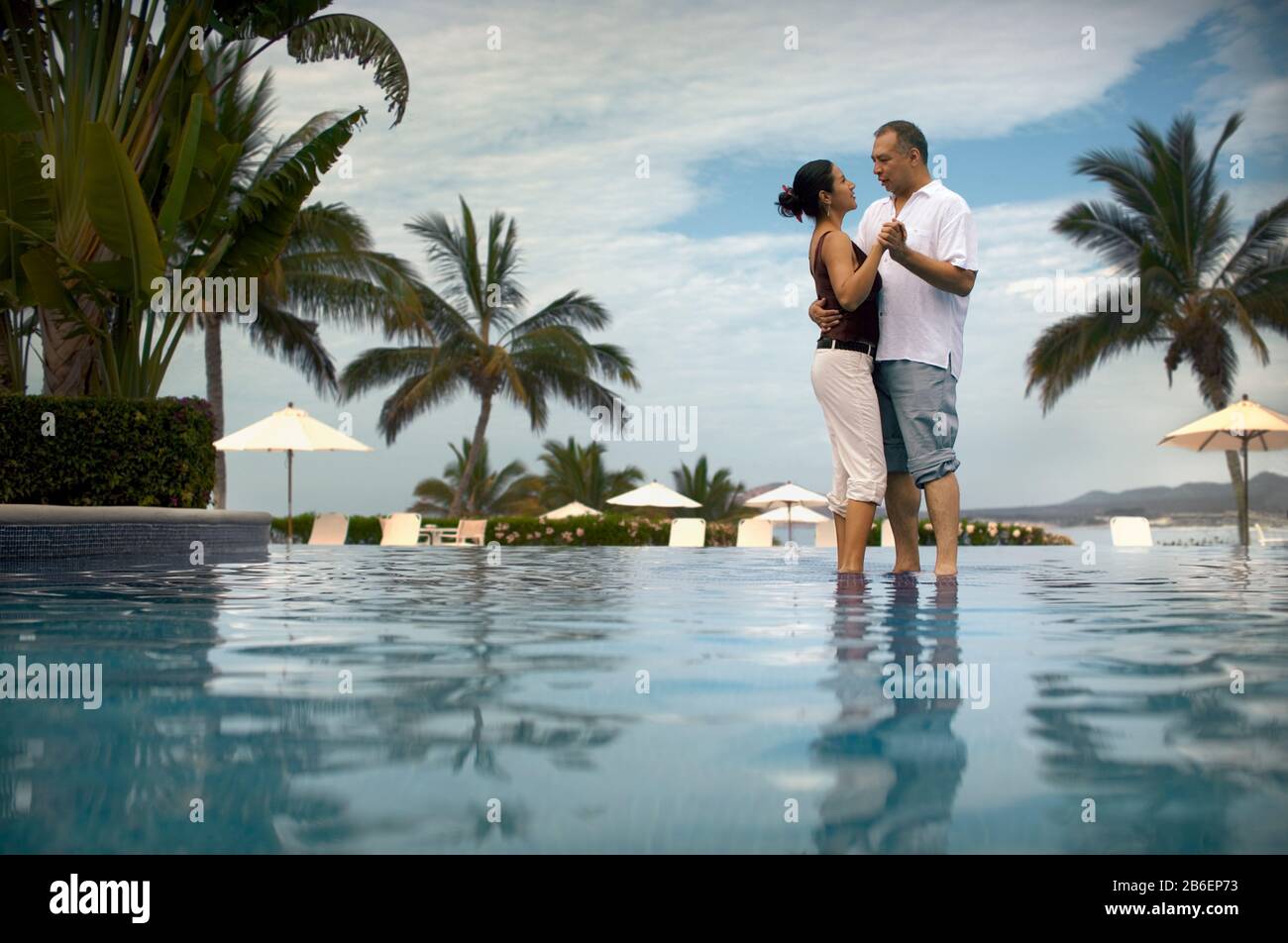 couple dancing by swimming pool Stock Photo - Alamy