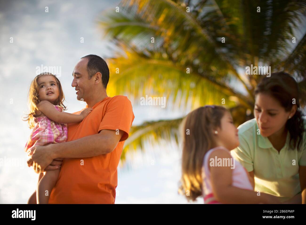 Parents have an affectionate moment with their children Stock Photo - Alamy