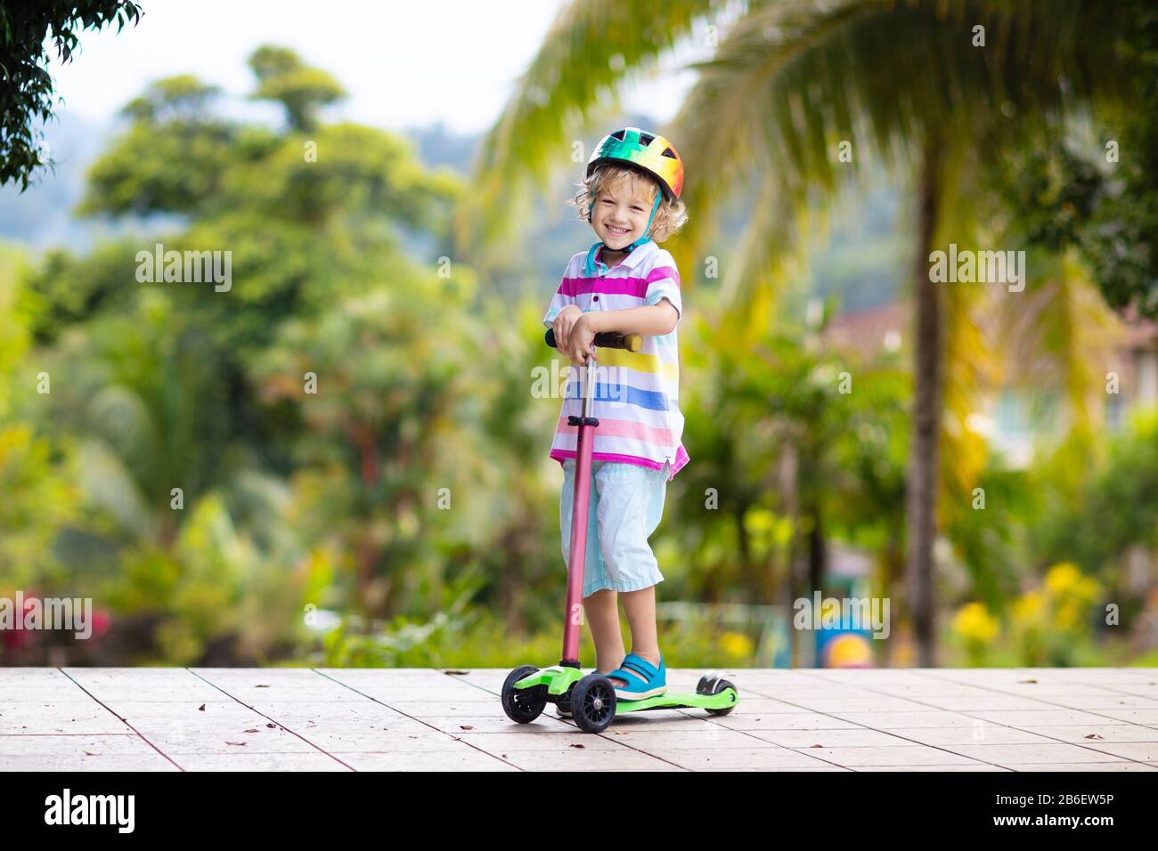 Little boy riding scooter. Kids ride kick board. Child playing on ...