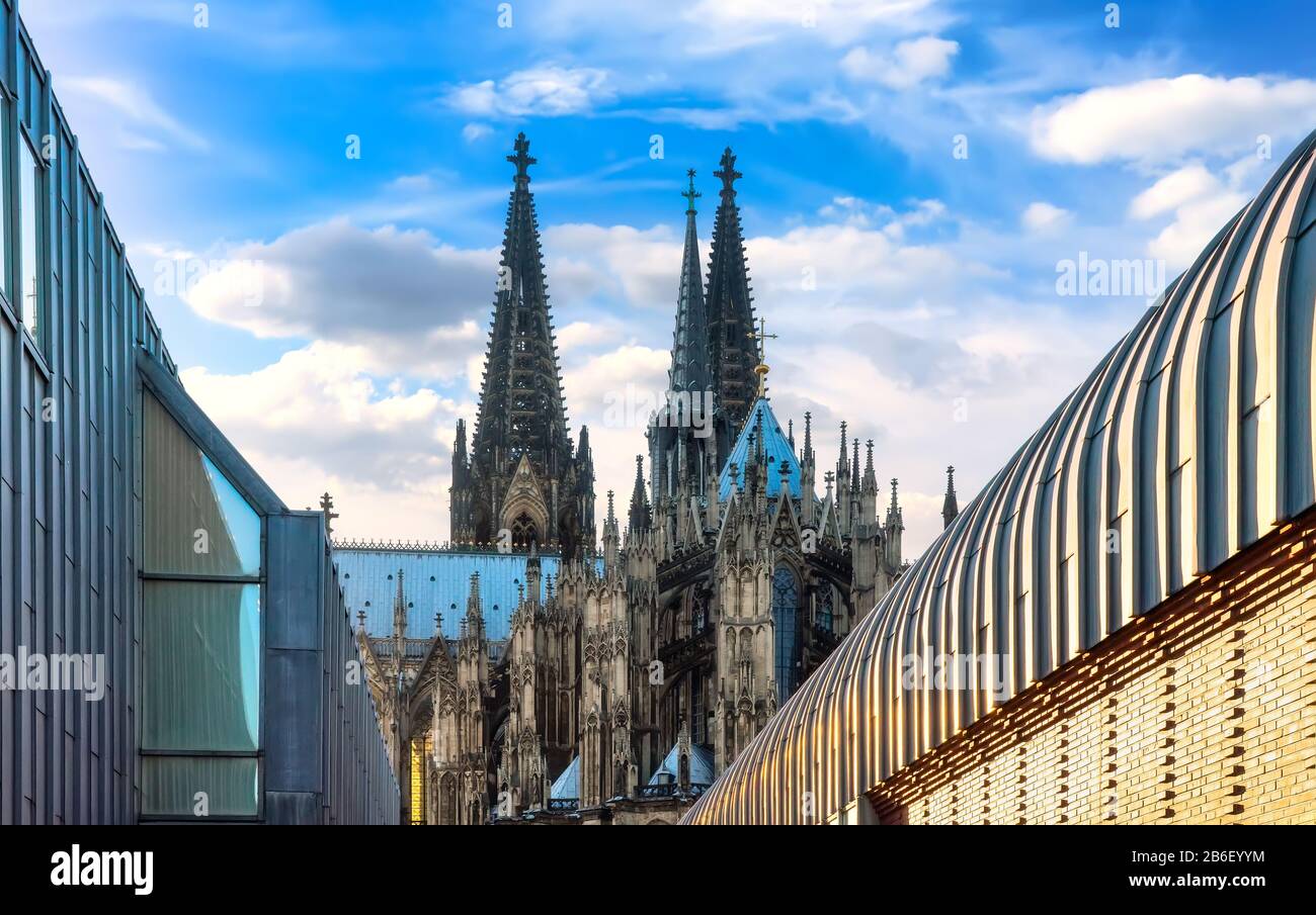 Modern philharmonic concert hall building with cathedral in background ...