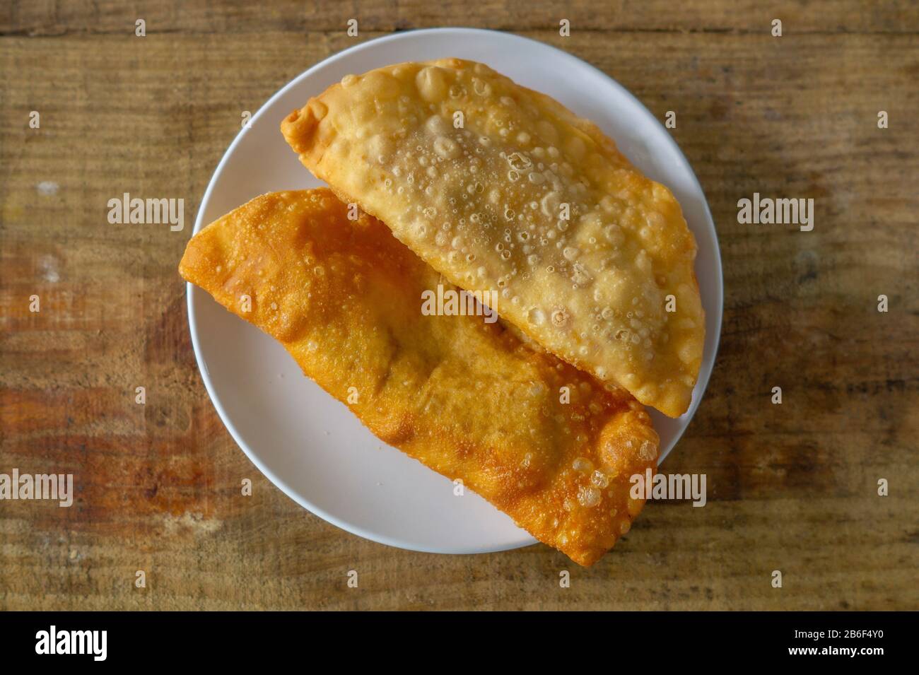 Fried Latin American empanadas with tomato and avocado sauce. Top view ...