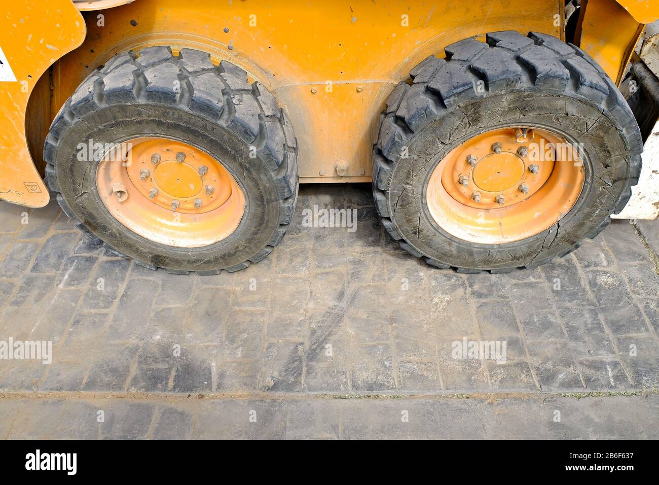 Black rubber heavy duty tyres of a construction equipment - top angled ...