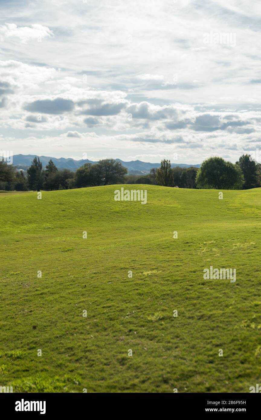 View of empty golf course with Cordoba Argentina mountain ranges and ...