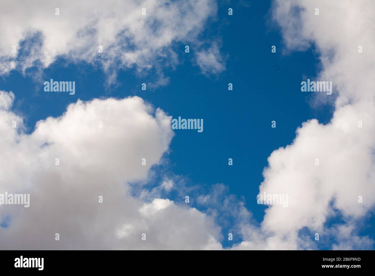 Breaking clouds open up to the sun and blue sky Stock Photo - Alamy